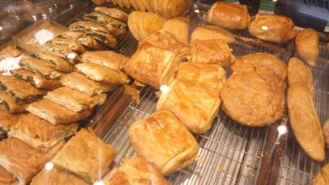 Greek pastry items layout behind glass s... | Stock Video | Pond5