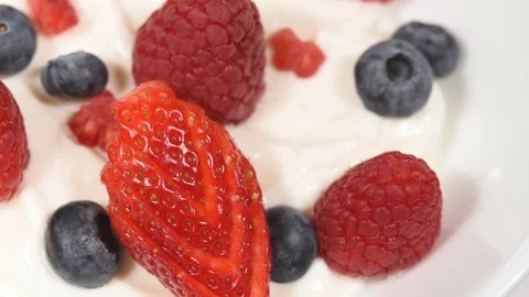 a greek yogurt with red fruits on top, y... | Stock Video | Pond5