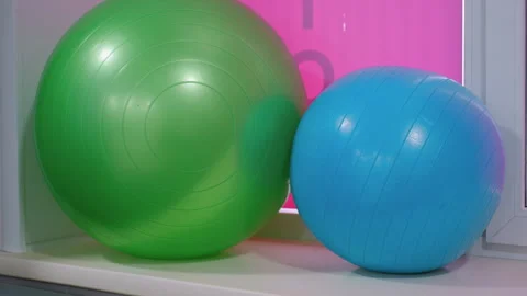 Green and Blue Stability Balls on White ... | Stock Video | Pond5