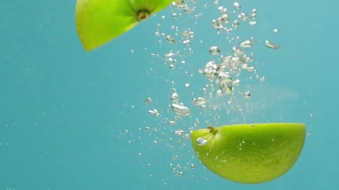 Green apple falling in boiling water, fr... | Stock Video | Pond5