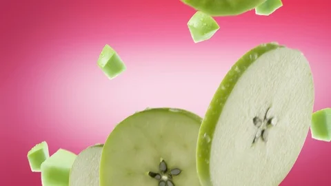 Green Apple with Slices Falling on Pink ... | Stock Video | Pond5