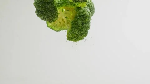 Green broccoli falling in boiling water,... | Stock Video | Pond5
