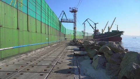 A green cargo sea vessel stands at the m... | Stock Video | Pond5