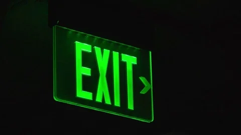 Green exit sign in dark showing way out ... | Stock Video | Pond5