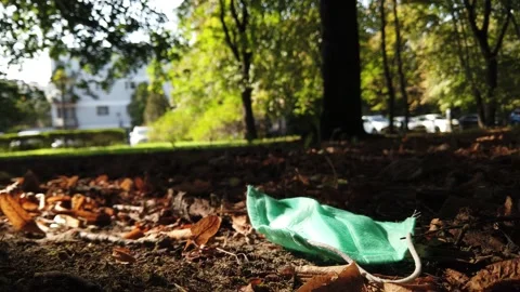 Green Face Mask Littered On The Ground A... | Stock Video | Pond5