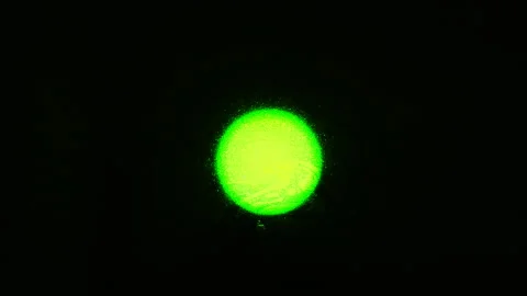 Green glowing ball on a black background... | Stock Video | Pond5