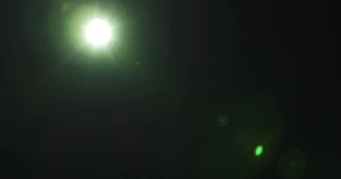 green lens flare artifacts over black ba... | Stock Video | Pond5