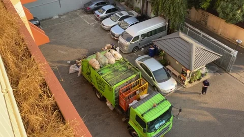 Green load garbage truck collecting tras... | Stock Video | Pond5