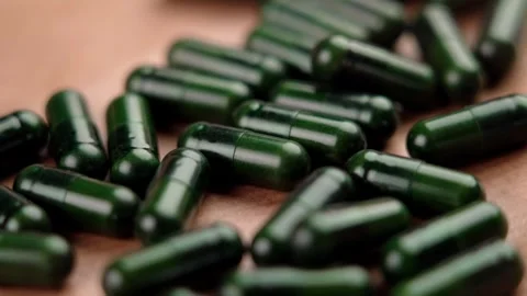 Green natural supplement capsules fallin... | Stock Video | Pond5