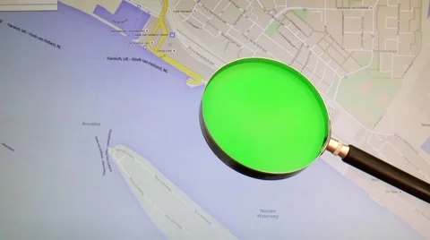 A green painted magnifying glass in fron... | Stock Video | Pond5