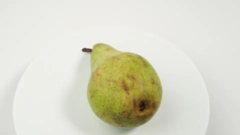 Green pear rotates on a white background... | Stock Video | Pond5
