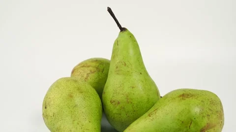 Green pear rotates on a white background... | Stock Video | Pond5