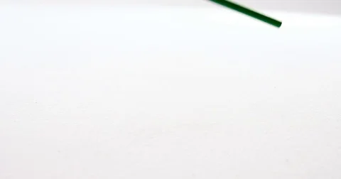 Green pencil falling on white background | Stock Video | Pond5
