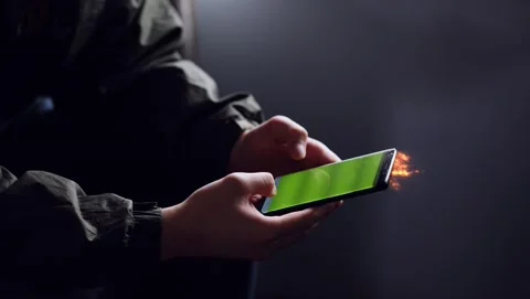 Green screen smartphone on fire in hands | Stock Video | Pond5