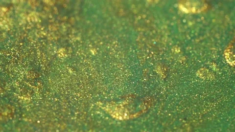 Green, yellow, gold, glitter paint flowi... | Stock Video | Pond5