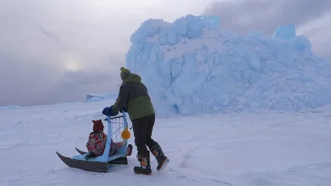 Greenland Inuit father, daughter, iceber... | Stock Video | Pond5