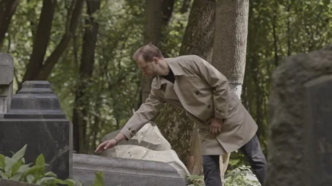 Grieving Man Standing by Gravestone at C... | Stock Video | Pond5