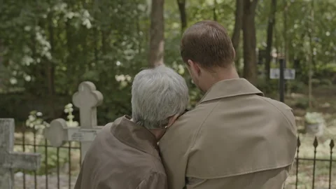 Grieving People Standing by Gravestone a... | Stock Video | Pond5