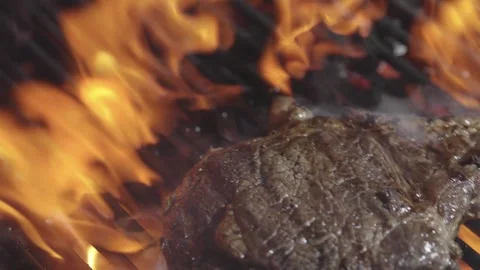 Grilled meat with fire. Roast meat with ... | Stock Video | Pond5