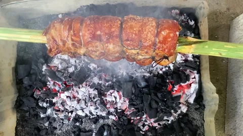Grilling lechon belly in the traditional... | Stock Video | Pond5