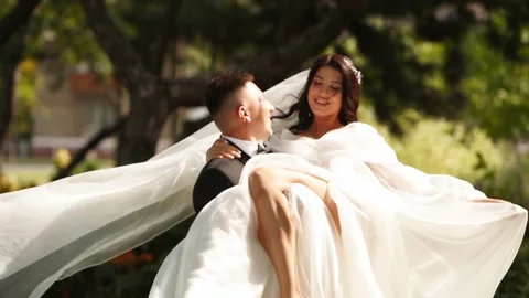 Groom spinning bride holding on his hand... | Stock Video | Pond5