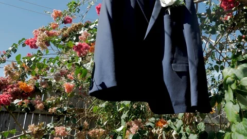 Groom Suit Hanging On colorful flower tr... | Stock Video | Pond5