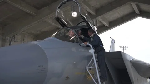 Ground crew standing on cockpit ladder s... | Stock Video | Pond5