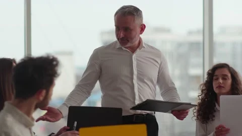 A group of businessmen sit down at the t... | Stock Video | Pond5