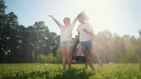 A group of children playing in the rain.... | Stock Video | Pond5