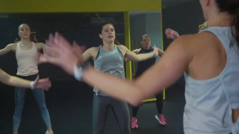 Group doing jumping jack exercises with ... | Stock Video | Pond5