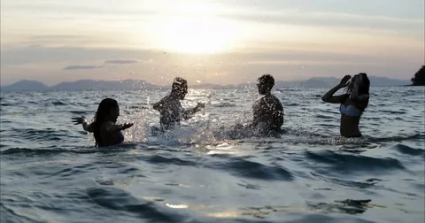 Group Of Friends Swimming In Sea At Suns... | Stock Video | Pond5