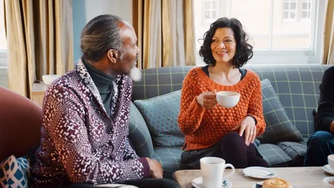 Group Of Middle Aged Friends Meeting Aro... | Stock Video | Pond5