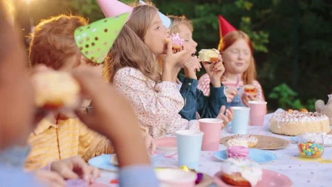 Group of multiracial children eating cak... | Stock Video | Pond5