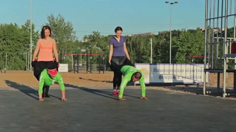 Group of people doing wheelbarrow exerci... | Stock Video | Pond5