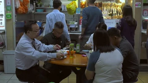 Group of people eating around a table at... | Stock Video | Pond5