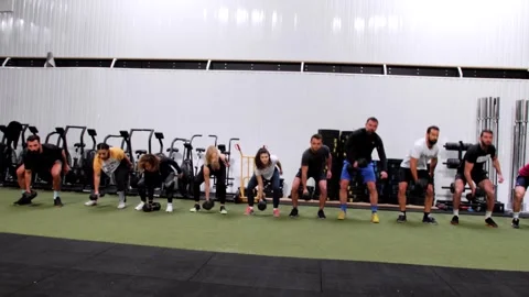 Group of people lifting a heavy dumbbell... | Stock Video | Pond5