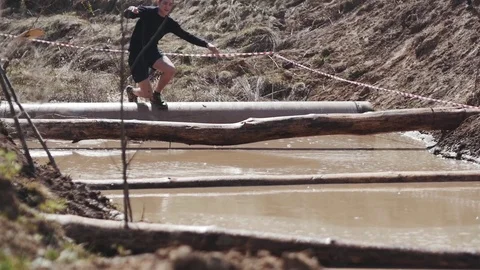 A group of people running through mud pi... | Stock Video | Pond5