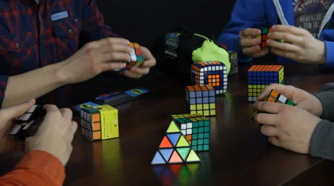 Group of People Solving Rubik's Cube | Stock Video | Pond5