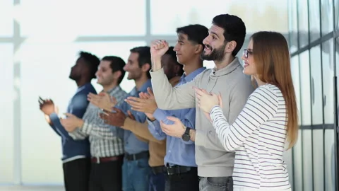 A group of people standing in a row clap... | Stock Video | Pond5