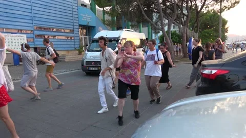 Group of people walk dancing in the cent... | Stock Video | Pond5