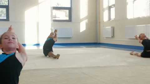 A group of plastic girls gymnasts exerci... | Stock Video | Pond5