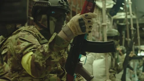 Group of Seated Soldiers Loading weapons... | Stock Video | Pond5