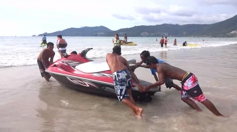 group of young guys pushing Jet ski into... | Stock Video | Pond5