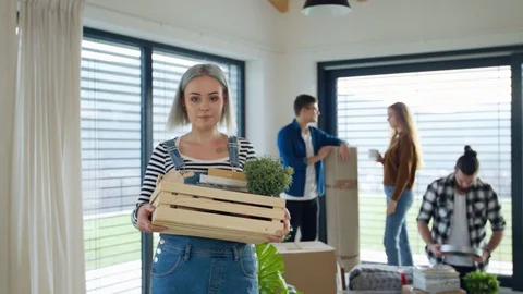 Group of young people moving in new home... | Stock Video | Pond5