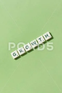 Growth formed of scrabble blocks on green background. ~ Premium Photo ...