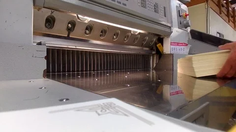 Guillotine operator sorting and cutting ... | Stock Video | Pond5
