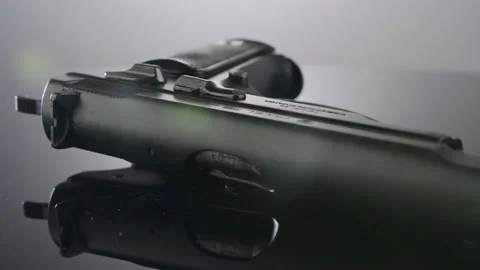 Gun Control. Studio shot of a 9mm gun ro... | Stock Video | Pond5
