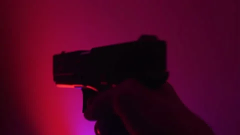 Gun shooting with red and blue backgroun... | Stock Video | Pond5