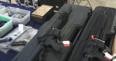 Gun Show - Pan of Assault Rifles | Stock Video | Pond5