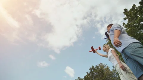 A guy and a girl launch toy airplanes in... | Stock Video | Pond5